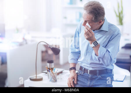 Nice pleasant man holding a paper tissue Stock Photo - Alamy