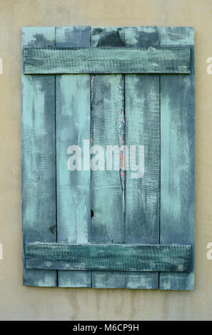 Boarded up window frame of an old house and rough wall background ...