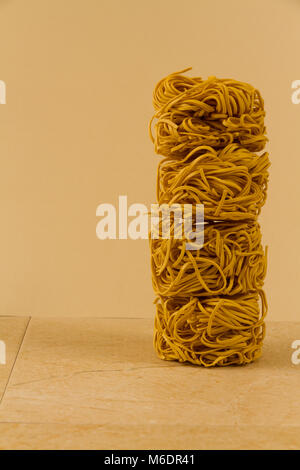 Stack of four noodle nests, copy space to left Stock Photo - Alamy