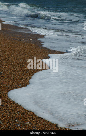 Waves washing on the shore of the shingle beach in England Stock Photo ...