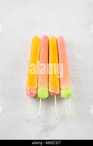 Multi-colored popsicles on a white background. Top view, copy space ...