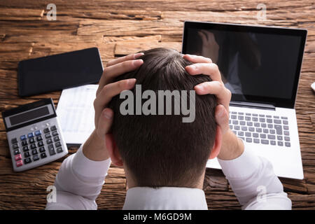 Front closeup view of businessman hand holding three wooden cubes ...