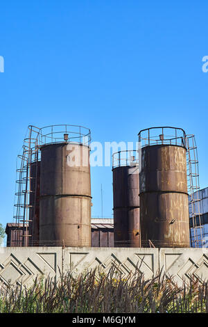 Old rusty industrial fuel storage tanks against blue sky Stock Photo ...