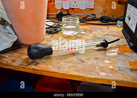Hydrometer for testing the charge of a car battery. The height of the ...