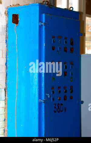 Old dismantled and rusty electrical panel assembly on an abandoned and ...