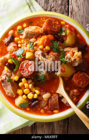 Cape Verde food cachupa with meat, sausages and vegetables close-up in ...