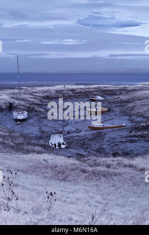 Infrared picture of boats high and dry on the edges of the creeks at ...