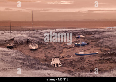Infrared picture of boats high and dry on the edges of the creeks at ...