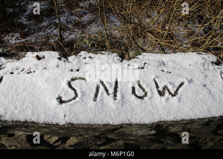 Winter word written on the snow surface Stock Photo - Alamy