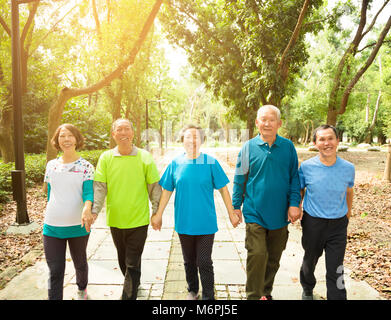 Happy senior Chinese friends exercising in park Stock Photo - Alamy