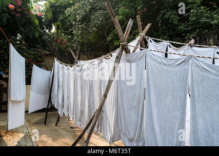 White sheets hang on ropes in Indian street Stock Photo - Alamy