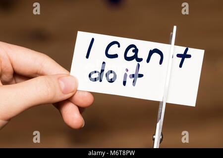Man using scissors to remove the word can't to read I can do it concept ...