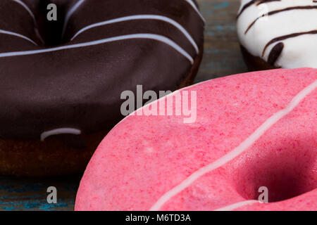 assorted donuts with chocolate frosted, pink glazed donuts Stock Photo ...