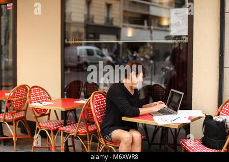 aged female screenwriter working with scenario in laptop Stock Photo ...