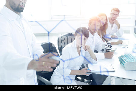 from behind the glass. a scientist standing near the blackboard in the ...