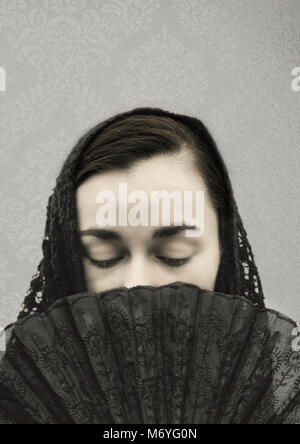 Hiding behind fan Stock Photo - Alamy