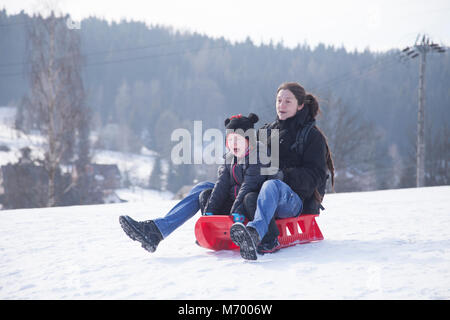 Kids enjoying snowy weather in winter time Stock Photo - Alamy