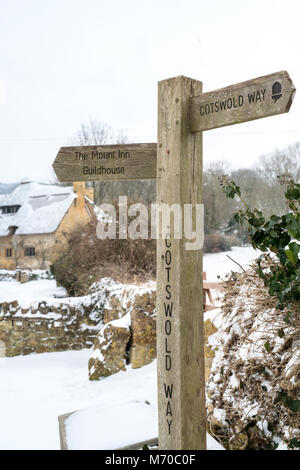Cotswold stone house and footpath signpost in Swinbrook, Oxfordshire ...
