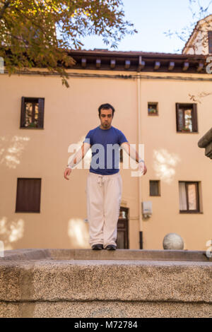 Athletic young man doing a jump wearing a sanitary mask-concept of the ...