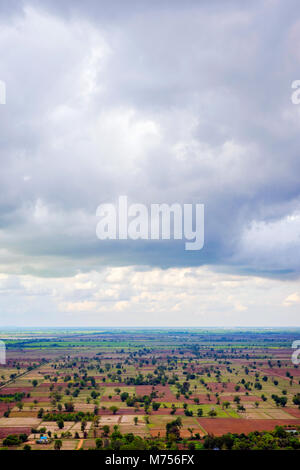 The view of green agricultural fields before the mountains at sunset ...