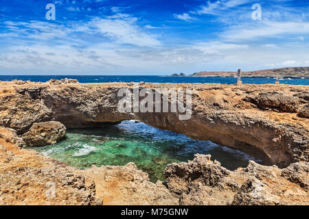 Natural arch or bridge on the Caribbean island of Aruba with waves ...