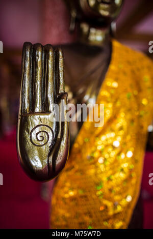 Golden buddha hand with spiral sign with shimmering yellow robe Stock ...