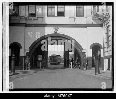 A historical photograph of the gate at a navy yard, depicting the ...