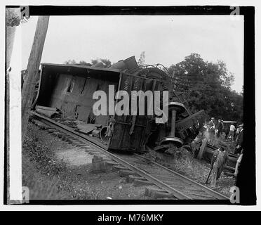 This historical image depicts a railroad accident in the early 1900s ...