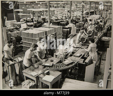 A historical image depicting the printing process of photos from the ...