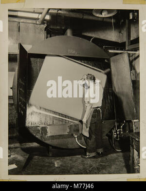 A photograph depicting the process of book manufacturing, specifically ...