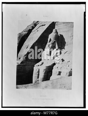 Three-quarter view of the colossal statues at Abou Simbel ...