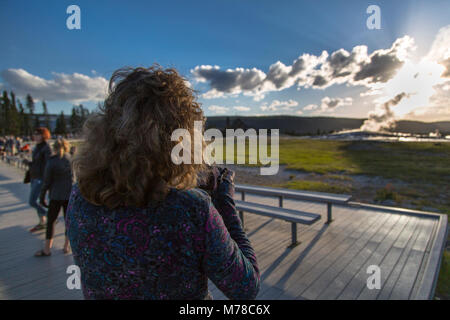 Photographing Old Faithful at Sunset Stock Photo - Alamy