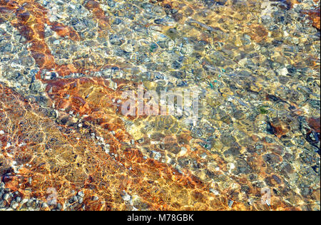 Rocks make coloured patterns seen through the seawater at Beidaihe ...