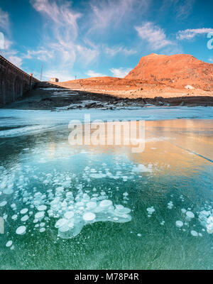 Frozen lake Montespluga at dawn, Chiavenna Valley, Sondrio province ...
