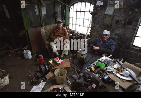 Engineers taking a lunch break in their workshop 1980s Stock Photo - Alamy