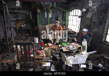 Engineers taking a lunch break in their workshop 1980s Stock Photo - Alamy