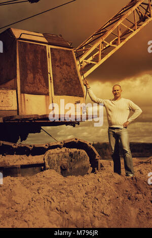 Portrait of tractor operator at sand pit Stock Photo - Alamy