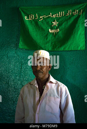 Sufi imam in front of islamic green flag, Harari region, Harar ...