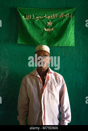 Sufi imam in front of islamic green flag, Harari region, Harar ...