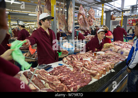 A butcher is traded in the meat range of Dorogomilovskiy market in ...