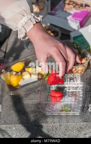 Man picks up juicy red currants in the garden Stock Photo - Alamy