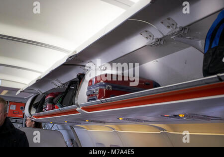 overhead locker on an airplane or plane Stock Photo - Alamy