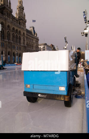 Zamboni resurfacing machine cleaning the ice on an outdoor skating rink ...