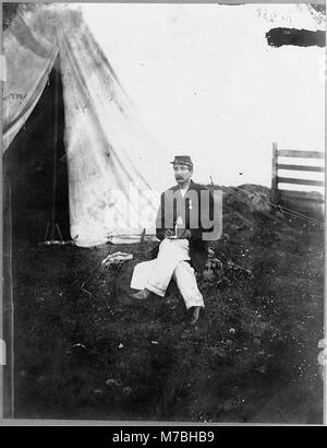 Capt. Huff's clerk, full-length portrait, seated, facing left, in front ...