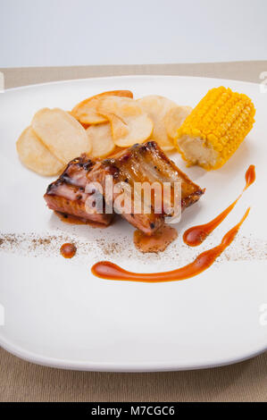Spare ribs served on a white plate Stock Photo - Alamy