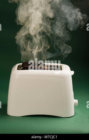 Smoke emerging from a burnt toast in toaster Stock Photo - Alamy
