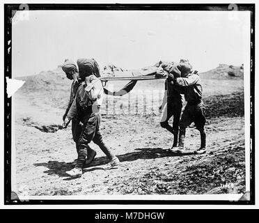 This historical image captures stretcher bearers rushing along a war ...