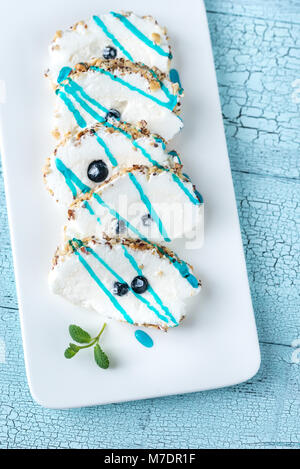 Sliced merengue roll with nuts Stock Photo - Alamy