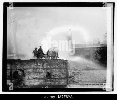 The image captures the aftermath of the Nixon Brewer fire at 7th and B ...