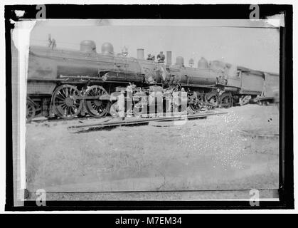 A photograph depicting a railroad wreck, capturing the aftermath of a ...